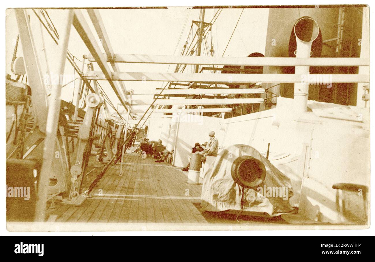 View along the lower deck of a large ocean liner, showing passengers ...