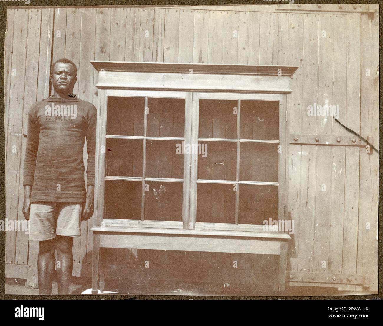 Nairobi Public Works Department apprentice standing next to a glass ...