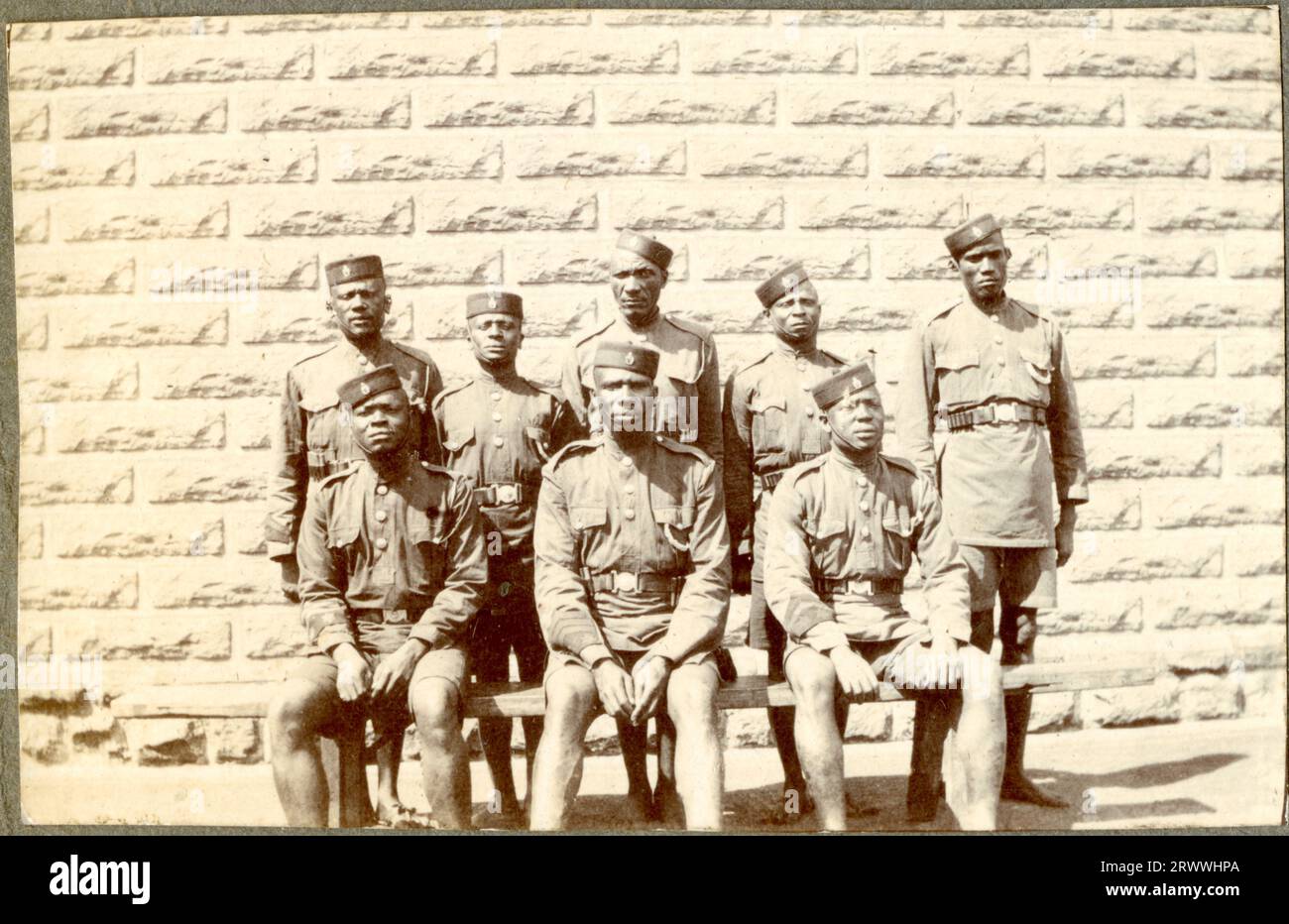View of part of the high prison wall from outside, with a tall tower in ...