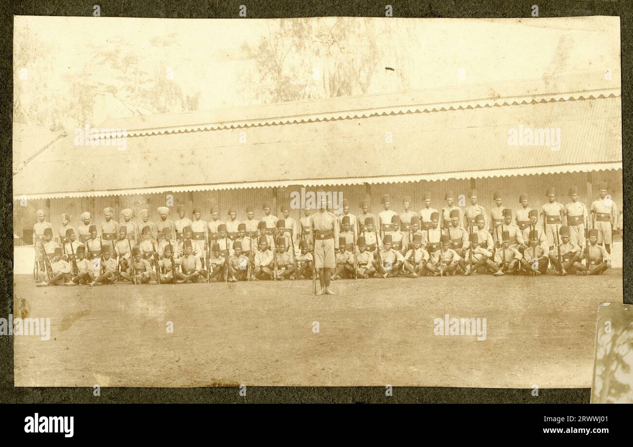 A European officer wearing military uniform supervises a group of 11 ...