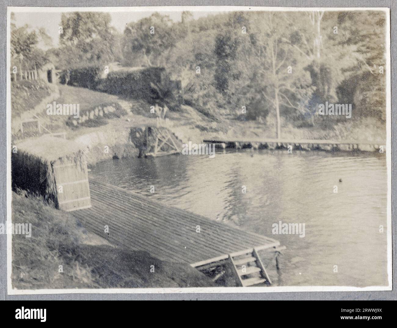 Mr Bungey sitting on rocks at the side of a pool, with a waterfall ...