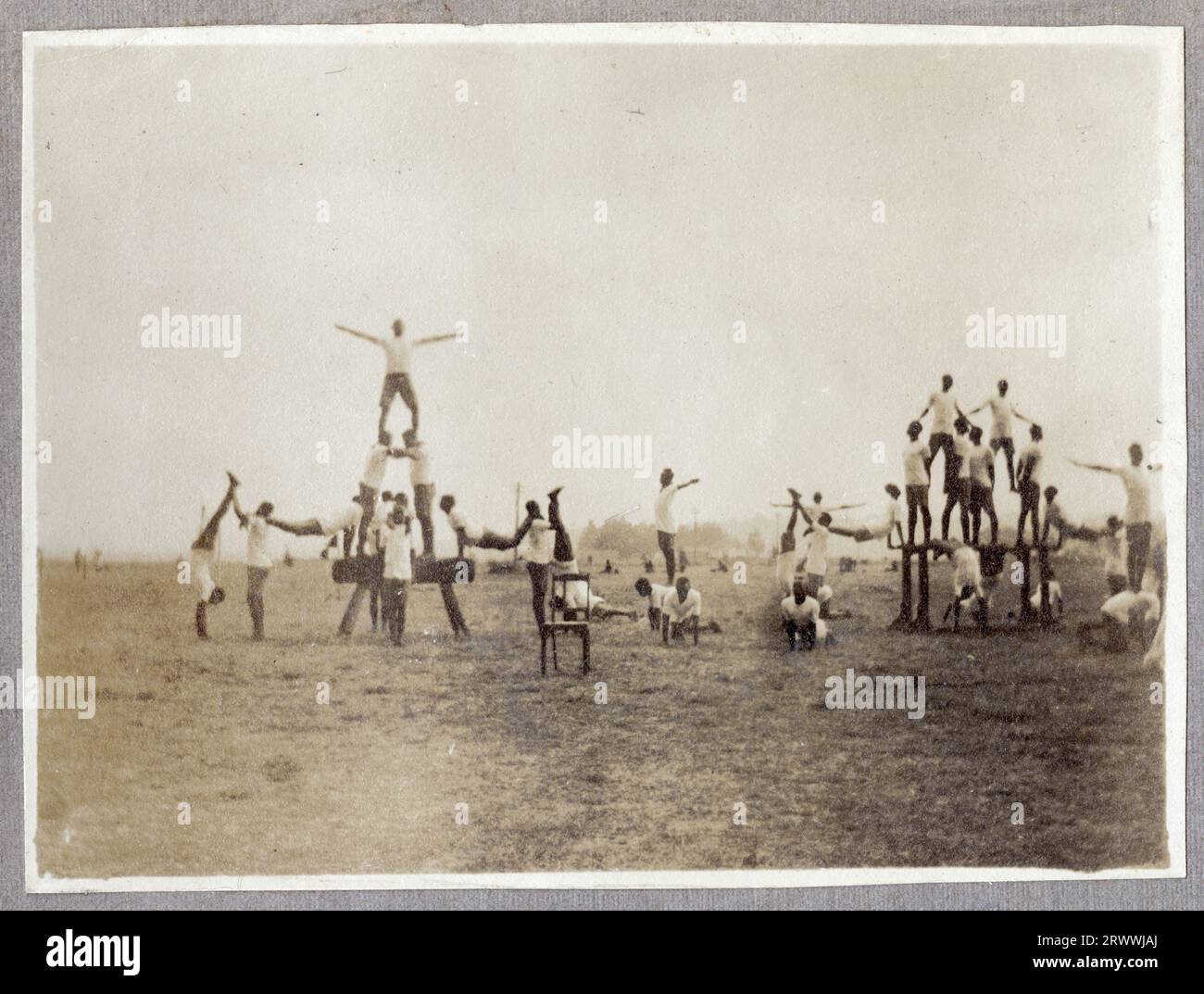 A barbed wire fence surrounds an enclosure in which there are several ...