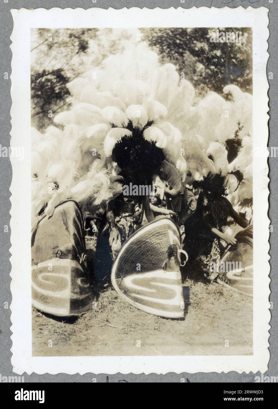 An African policeman, in uniform but barefoot, stands in the middle of ...
