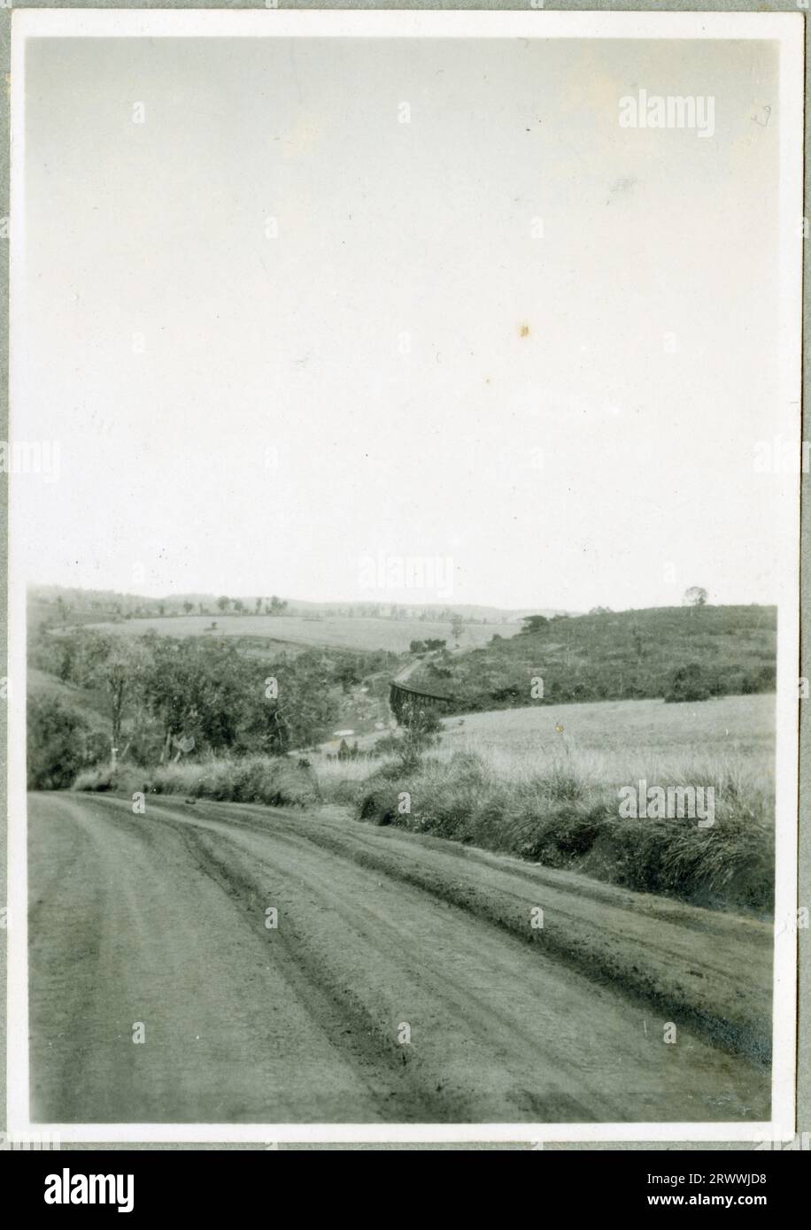 Landscape view of a dirt track road through the open bush, with fields ...