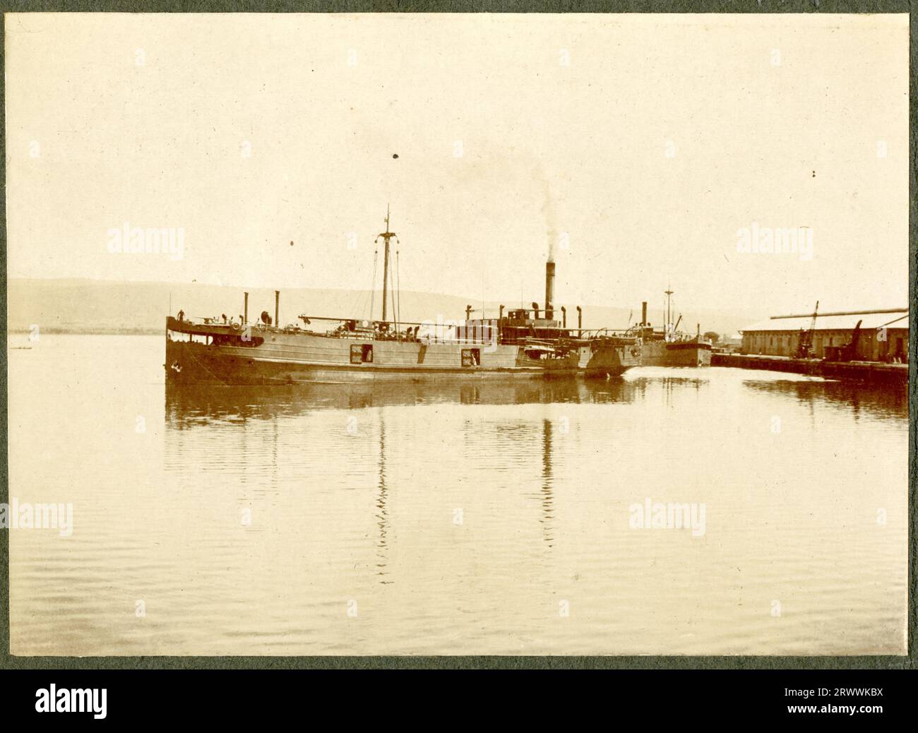 The steamer SS Usoga is seen across water moving away from the docks at ...
