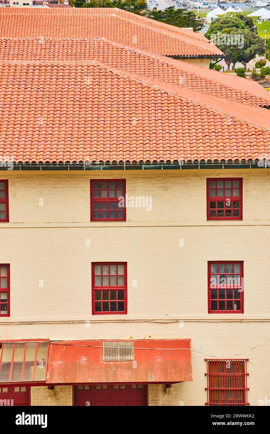 Cream colored building with red trim around windows and orange clay ...