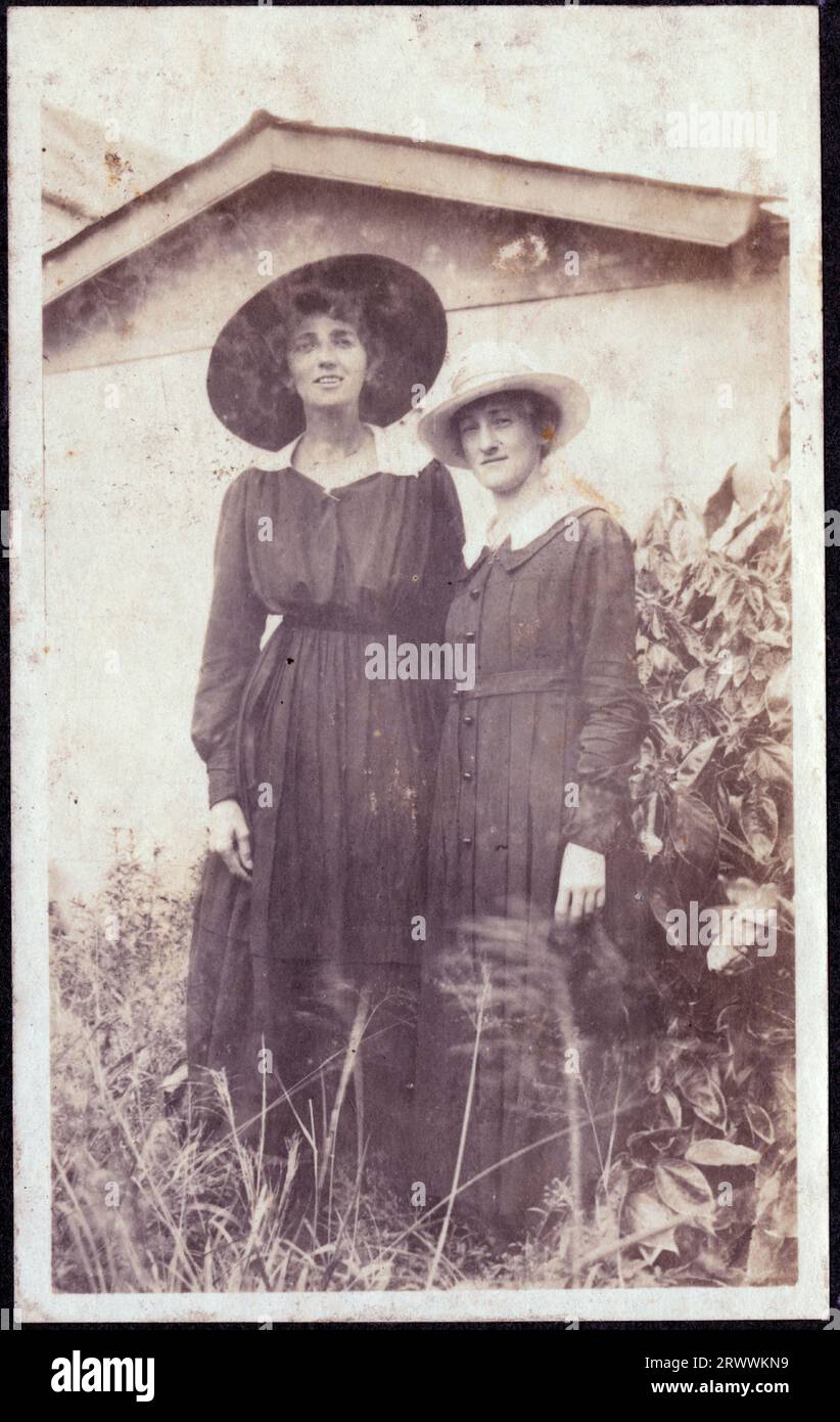 Portrait of two European women in smart dress, standing together in a ...
