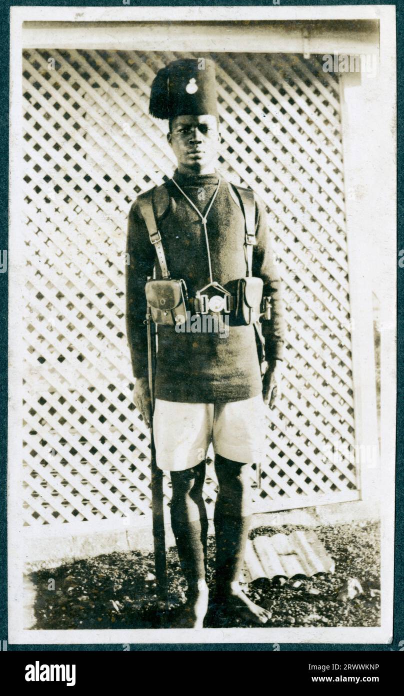Portrait of an African policeman standing outside in full uniform. The ...