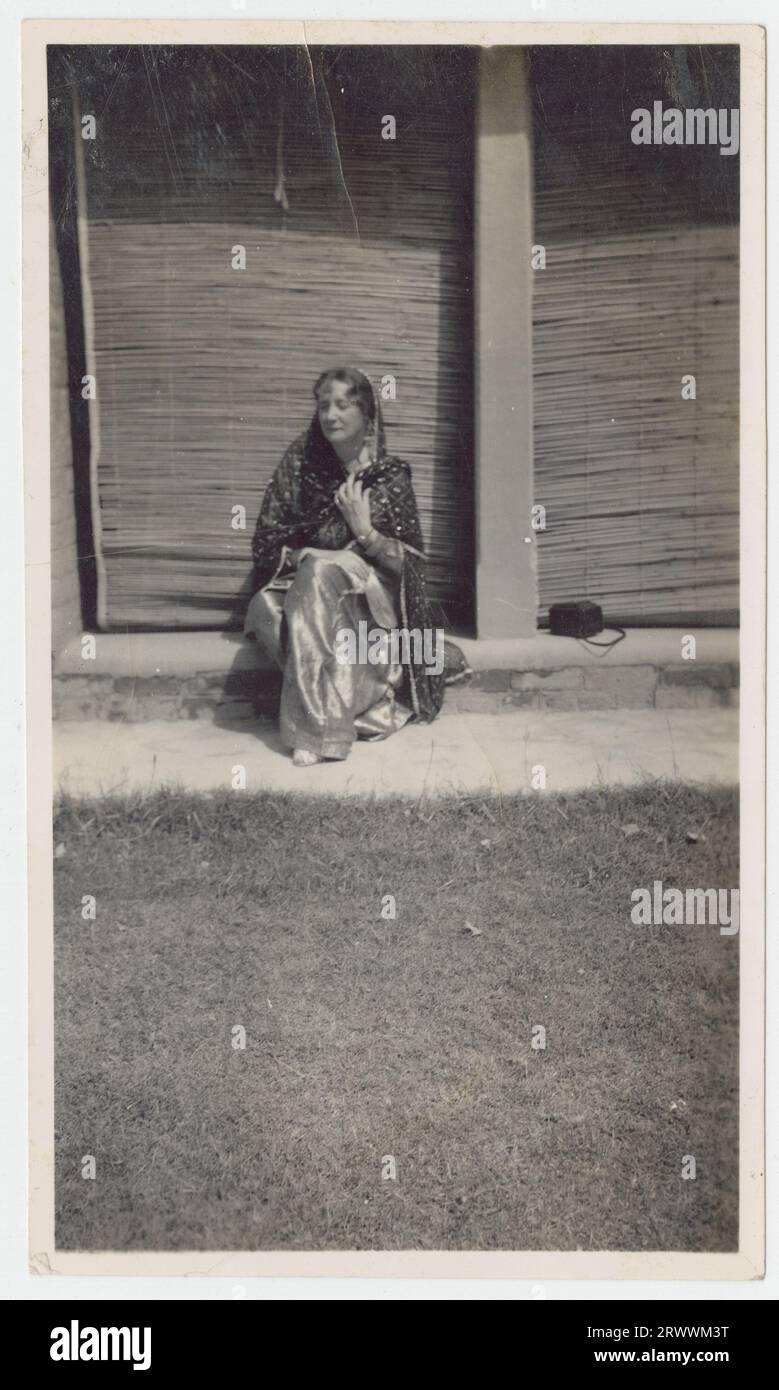 Woman in sari seated on a step. Caption reads: English lady in native ...