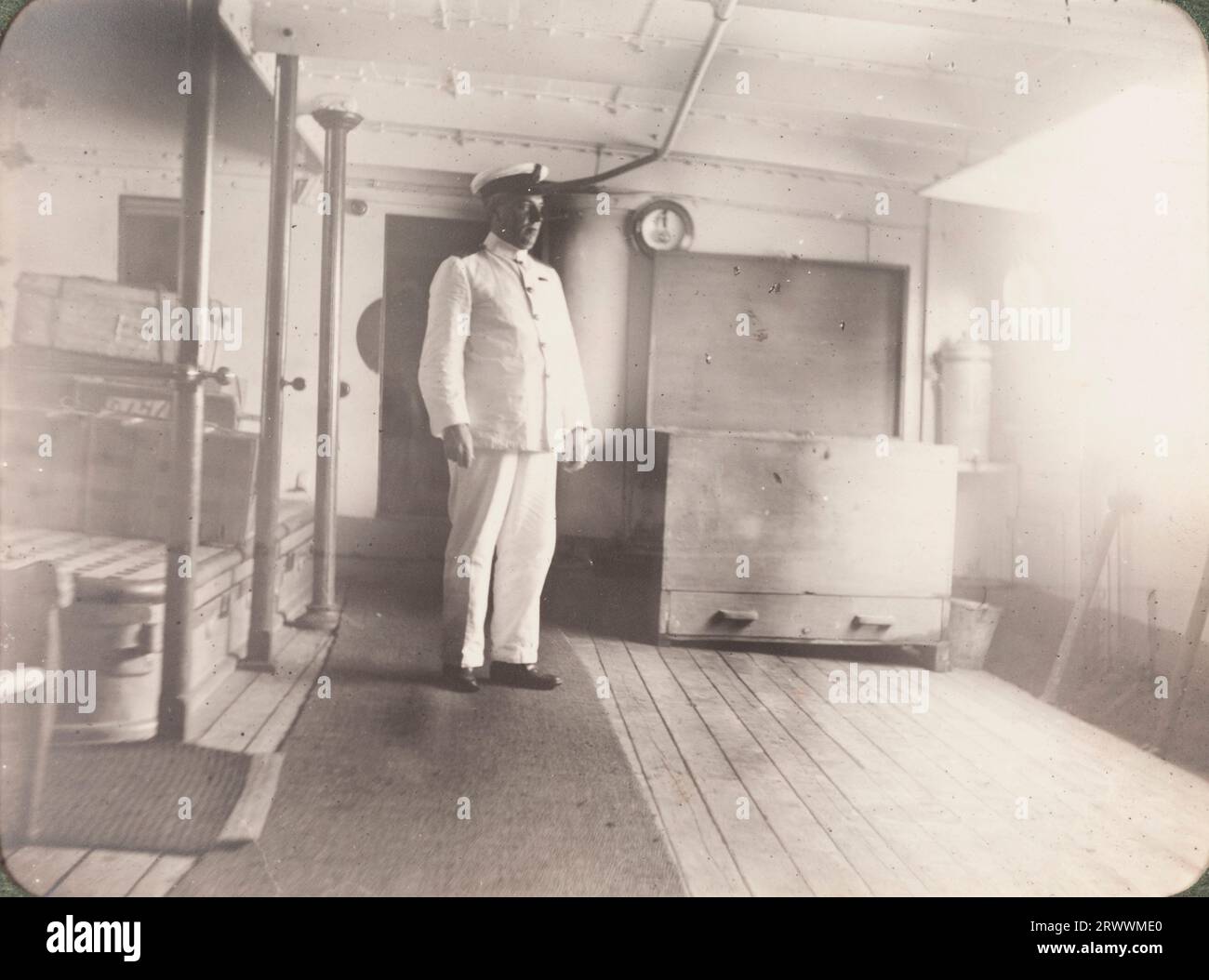 Officer in uniform standing on deck. This is presumed to be G E Wood ...