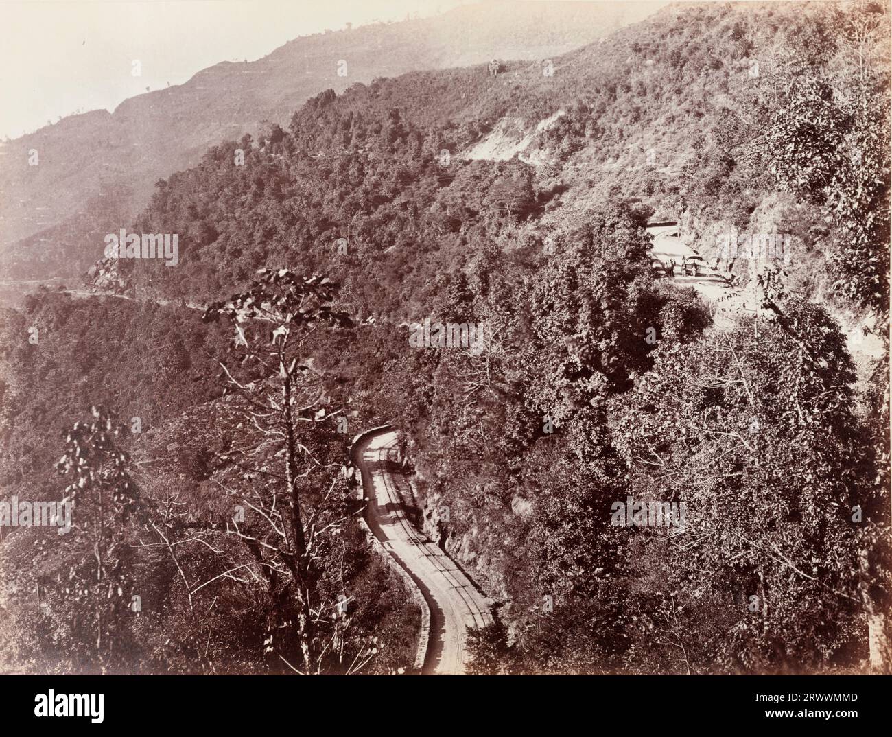 A view of a hillside with two sections of railway track in view ...