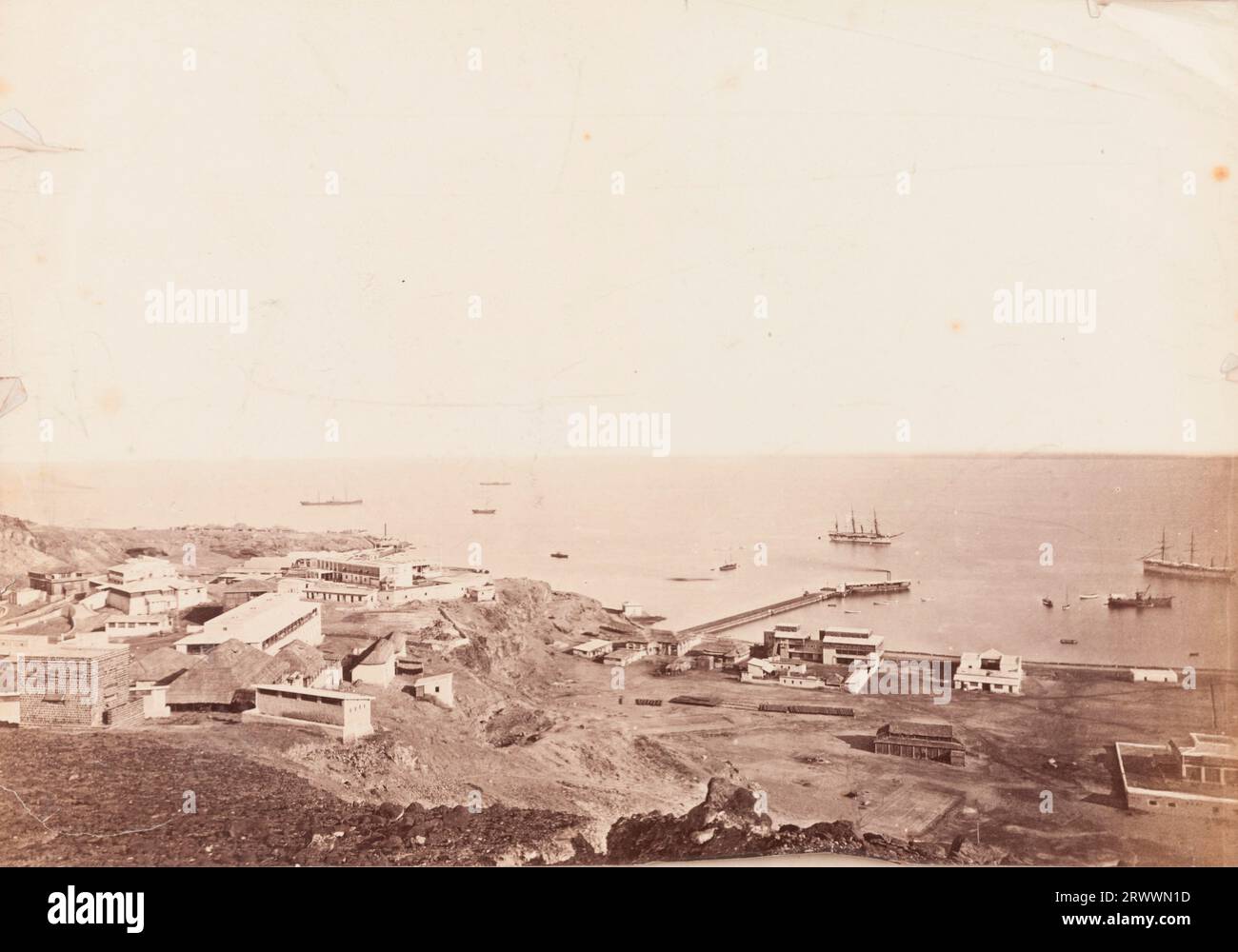 View of Aden Harbour looking out to sea. There are several buildings in ...