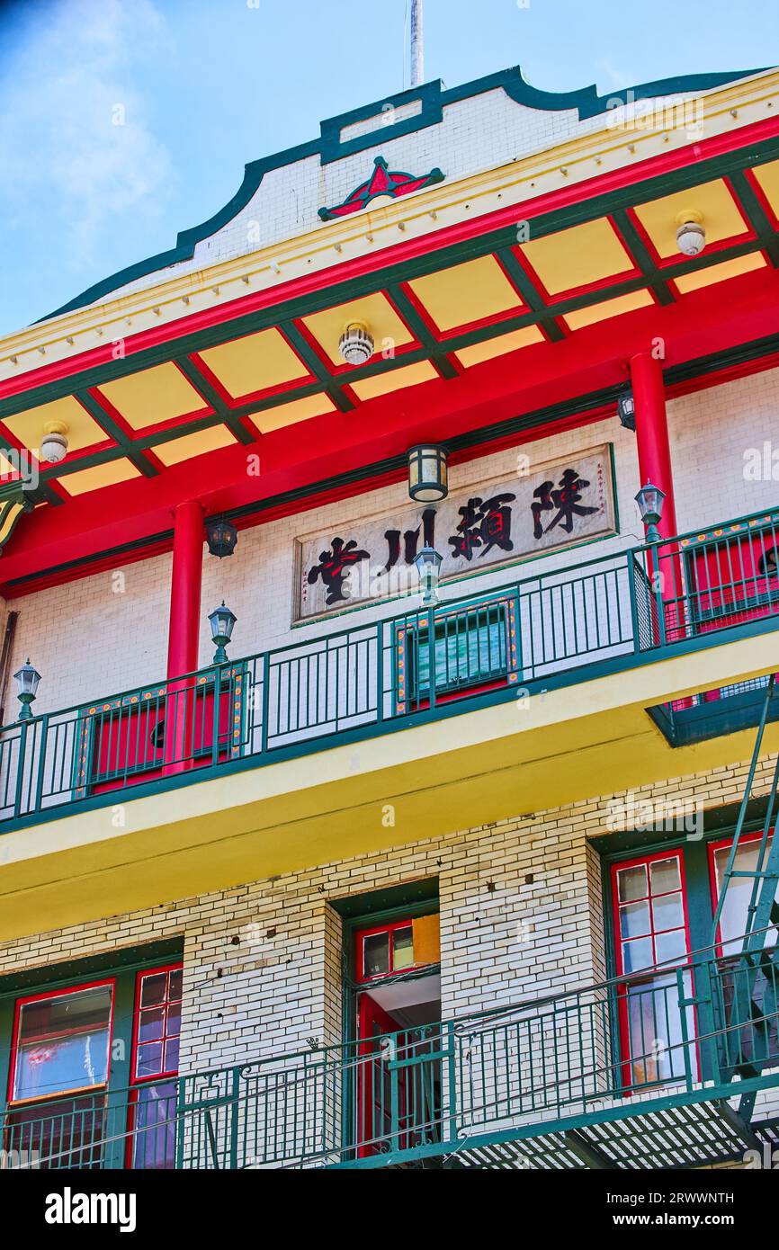 Red beams and yellow and green trim on Chinese building with green fire ...