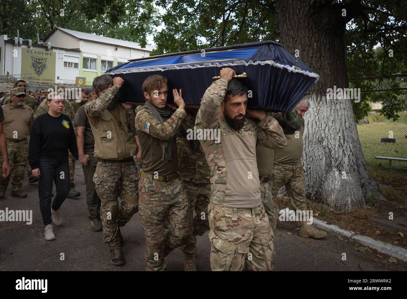 Volunteers of the Georgian legion carry a coffin of their comrade ...