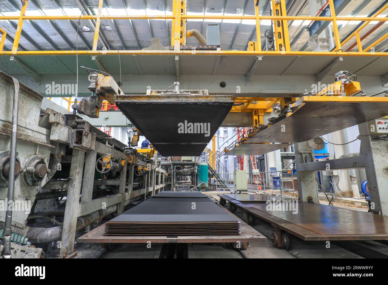 Workers work nervously on the production line of new building materials ...