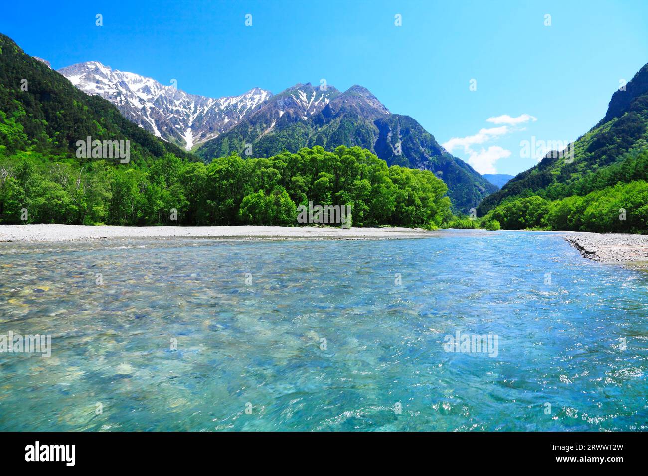 The Hotaka mountain range with lingering snow in the clear stream of ...