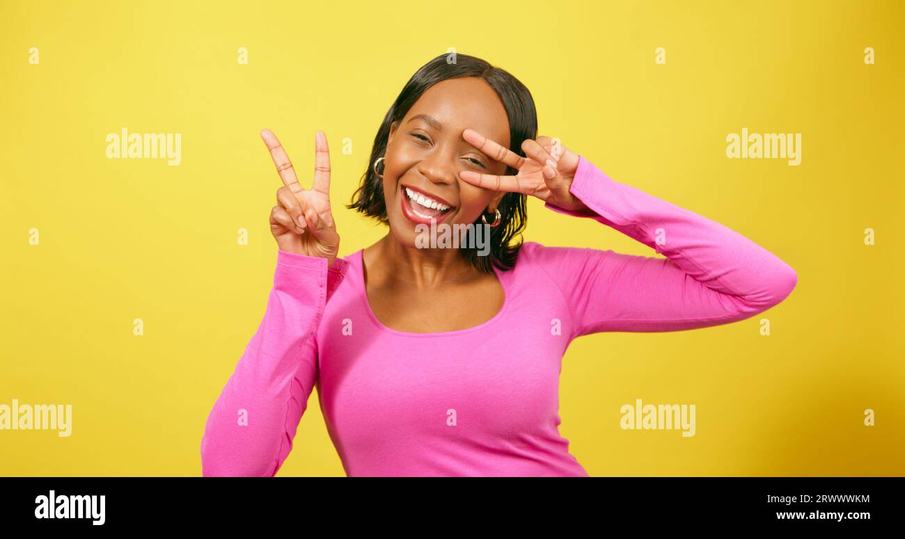Happy young woman holds peace hi-res stock photography and images - Alamy