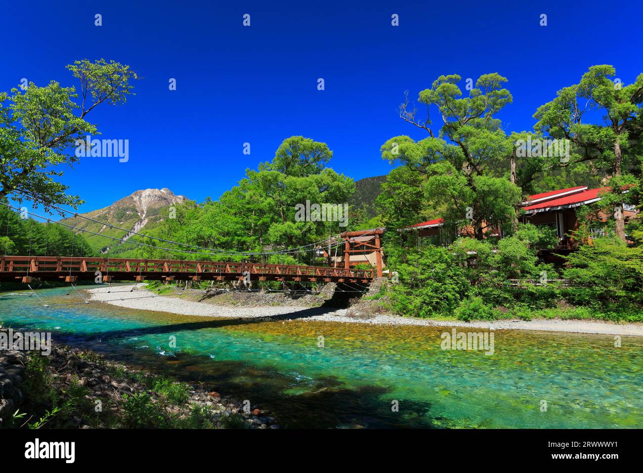 Kappa Bridge and Mt. Yake in clear sky at Azusa River, Kamikochi Stock ...