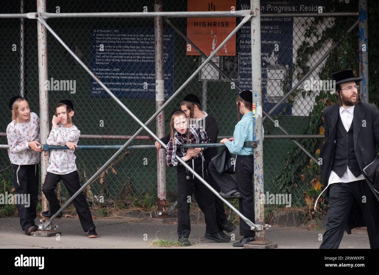 A street scene in a Hasidic Jewish neighborhood. Schoolboys wait for ...