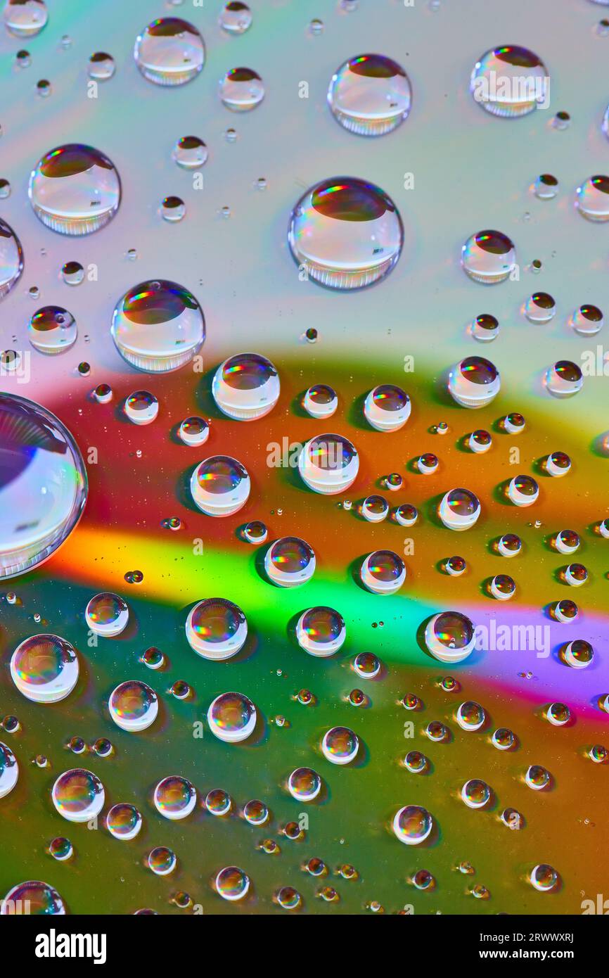 Laser burst of rainbow light across reflective metallic surface with ...