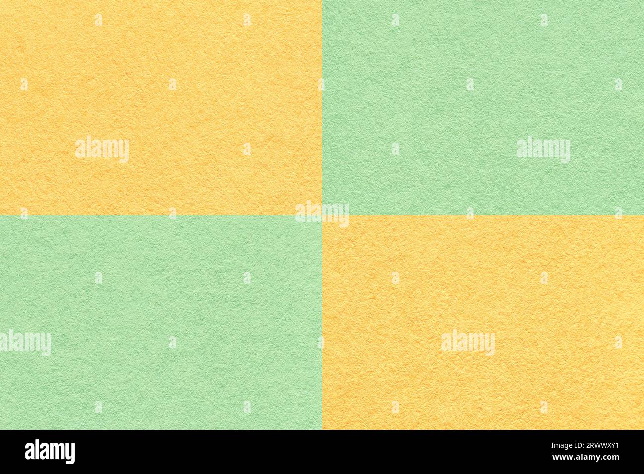 Texture of craft light green and yellow paper background with cells ...