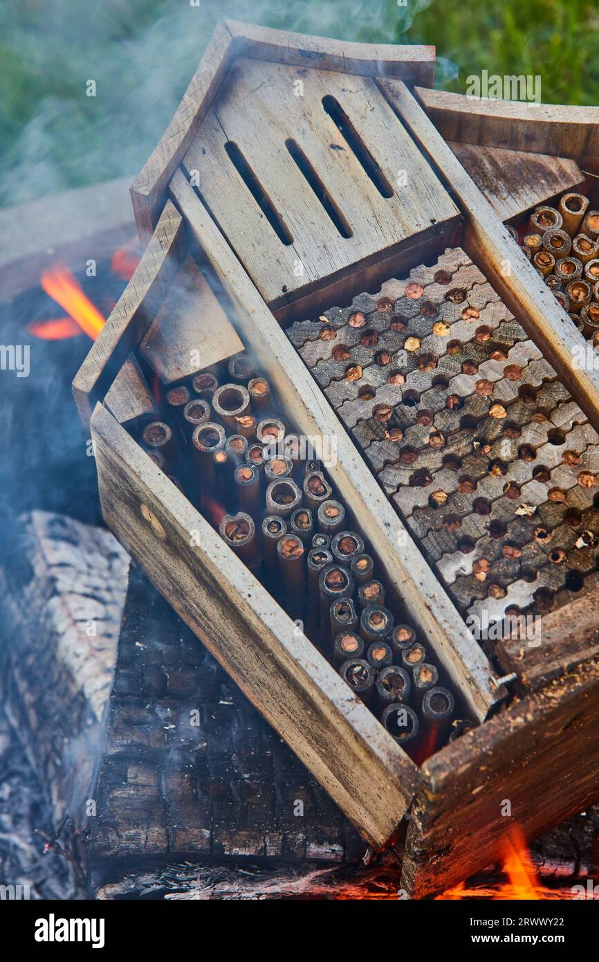 Smoke flowing through burning wooden beehive with smoke and ashes Stock ...