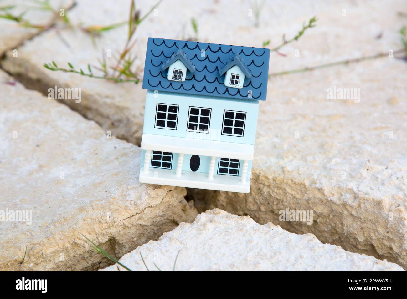 A small house on the edge of a precipice, the concept of an earthquake ...