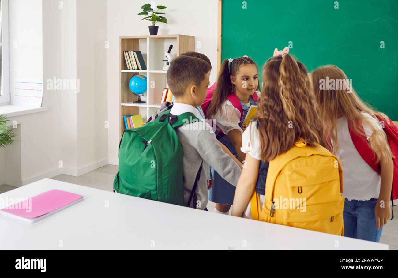 Elementary school students, classmates joining hands standing in round ...