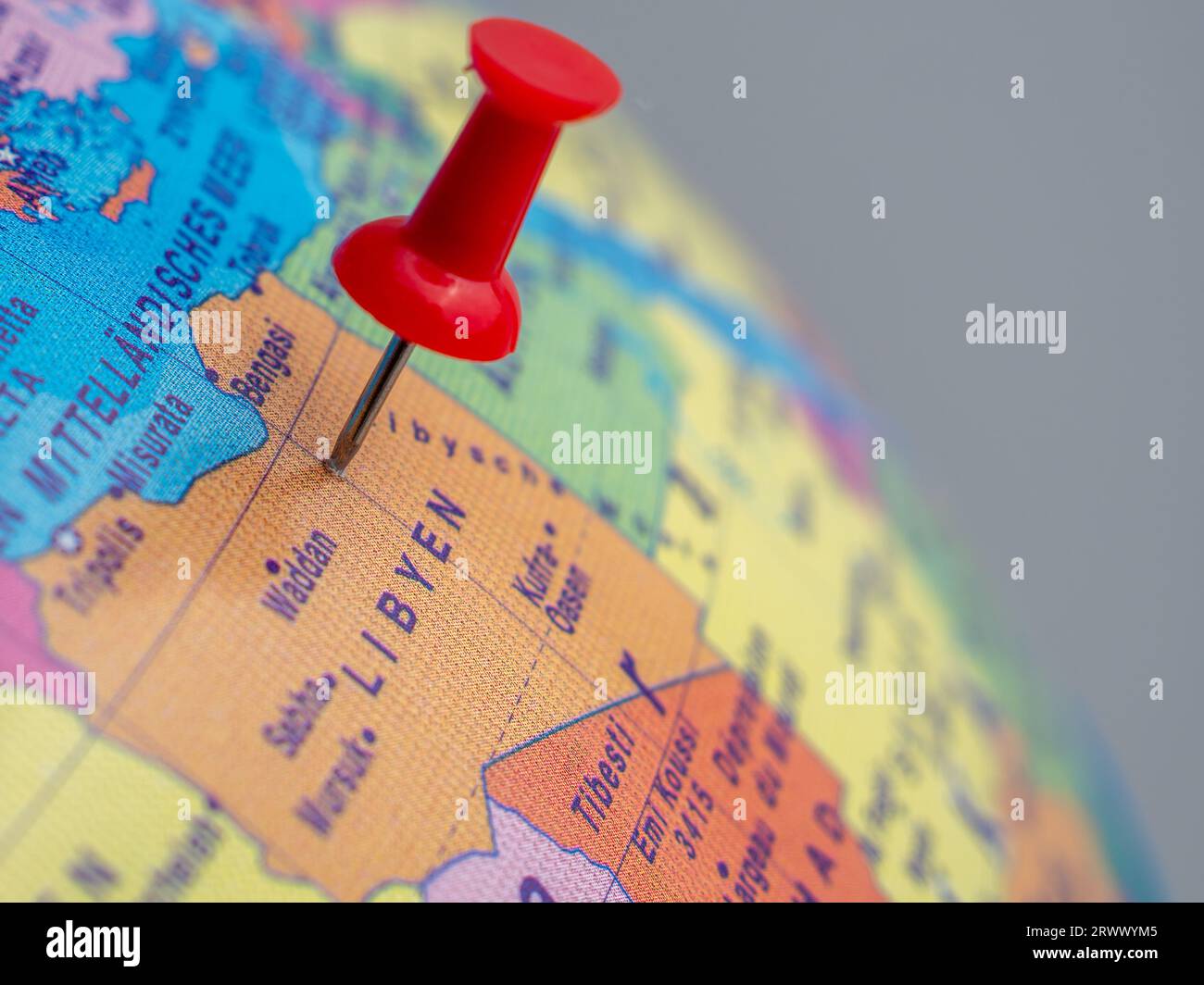 The globe indicates the country of Libya with a push pin. The country ...
