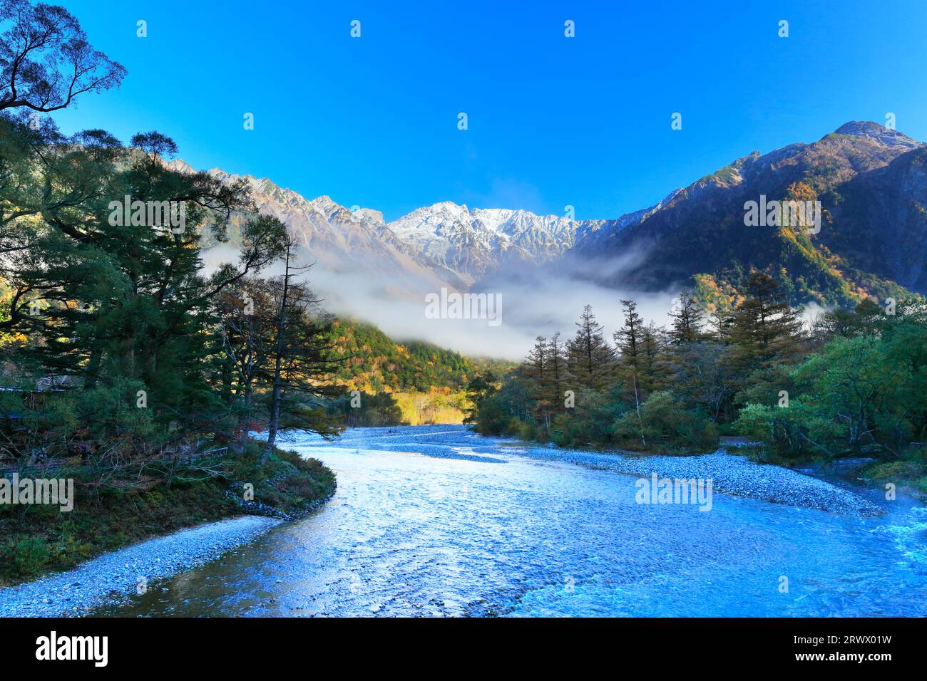 The clear stream of Azusa River and snow capped Hotaka mountain range ...
