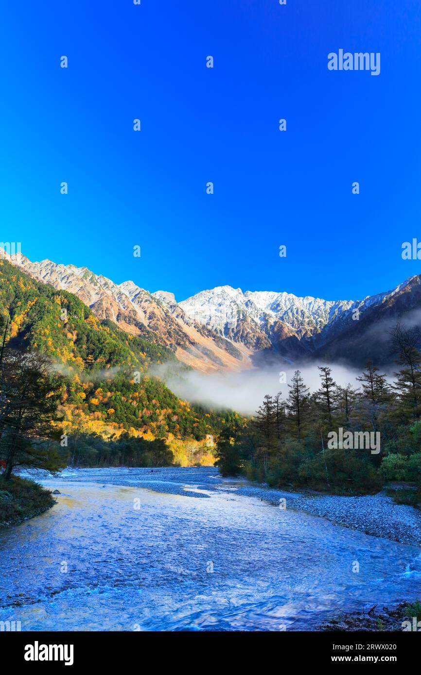 The clear stream of Azusa River and snow capped Hotaka mountain range ...