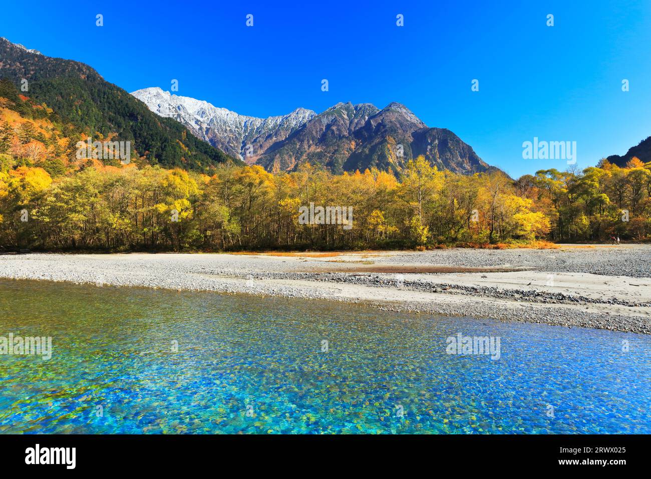 Clear stream of Azusa River and snow capped Hotaka mountain range in ...