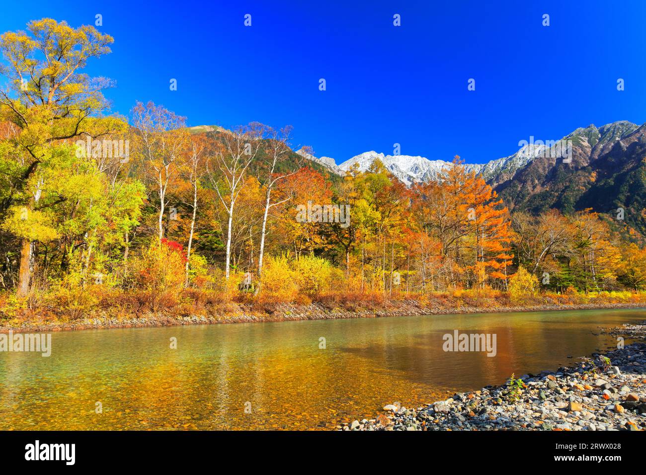 Clear stream of Azusa River and snow capped Hotaka mountain range in ...