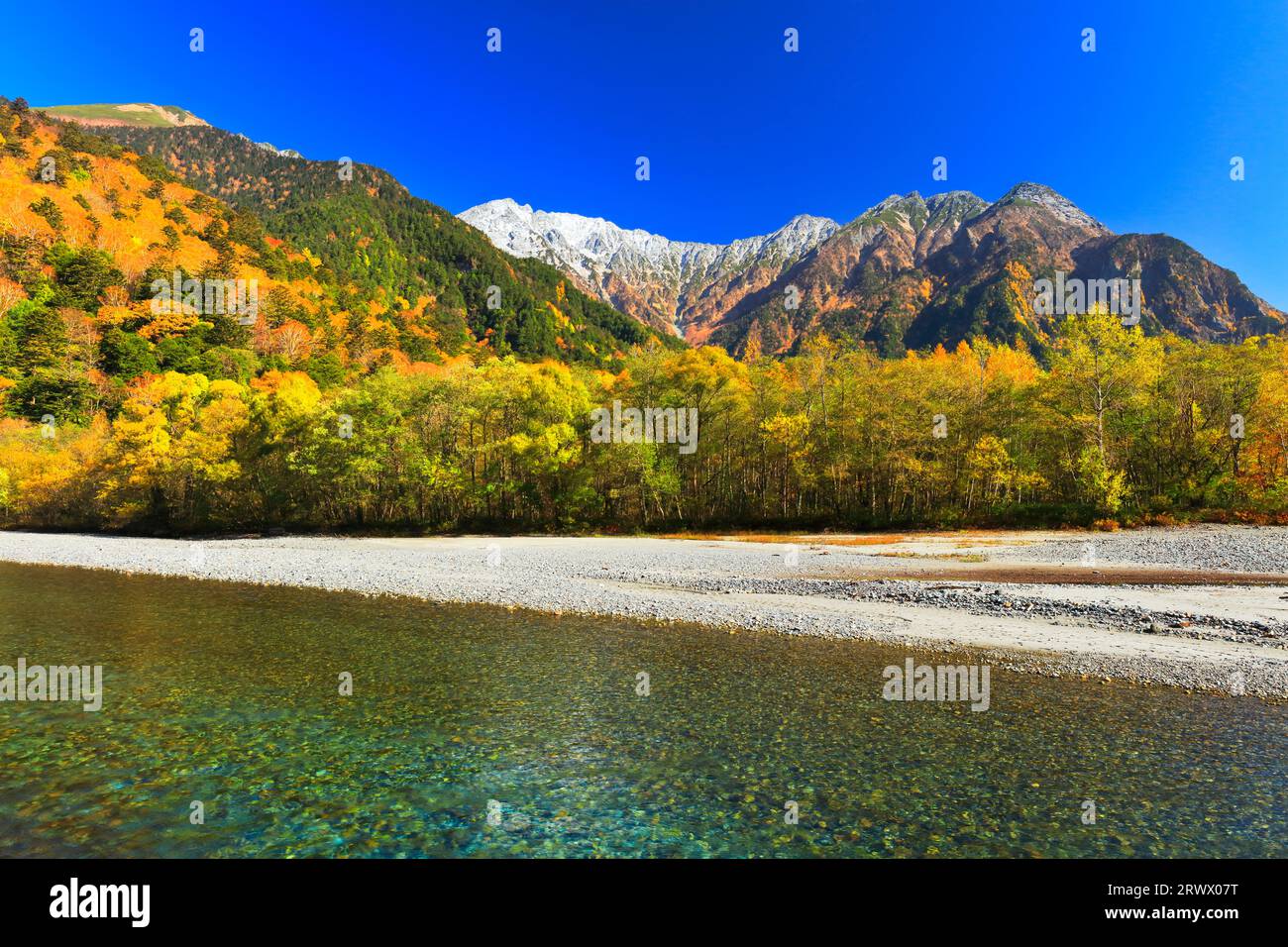 Clear stream of Azusa River and snow capped Hotaka mountain range in ...