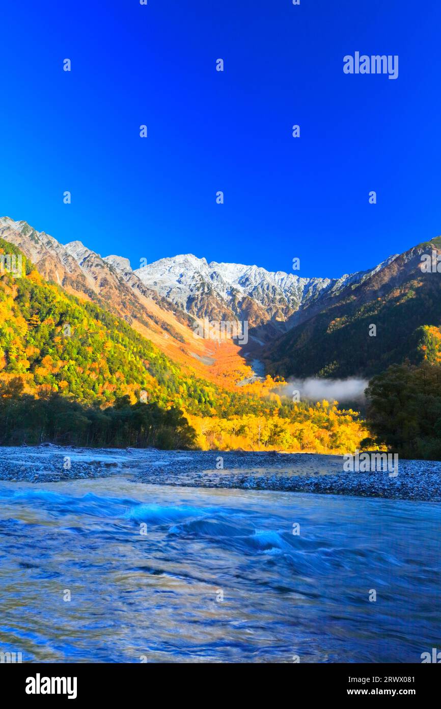 Clear stream of Azusa River and snow capped Hotaka mountain range in ...