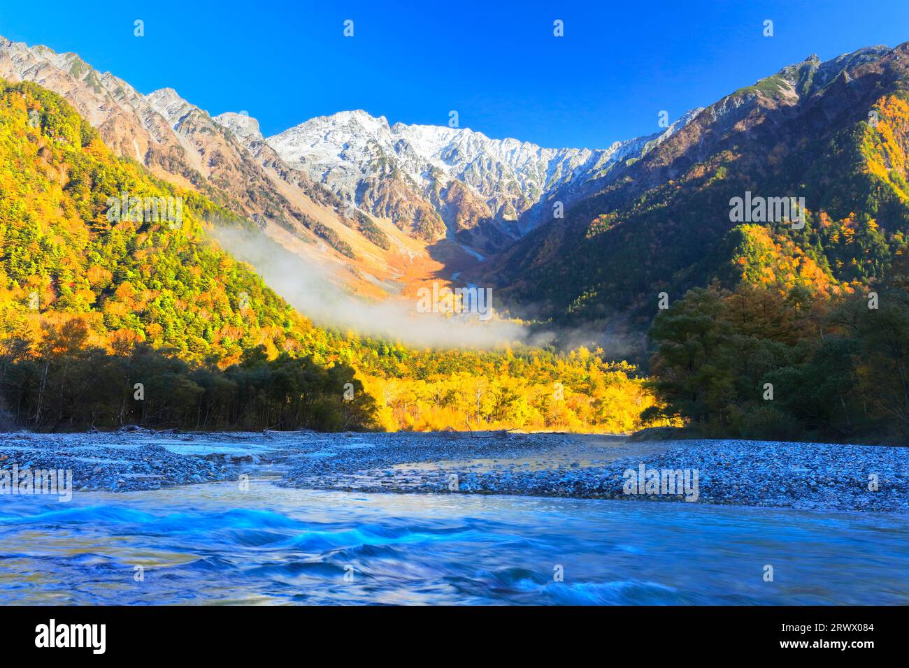 Clear stream of Azusa River and snow capped Hotaka mountain range in ...