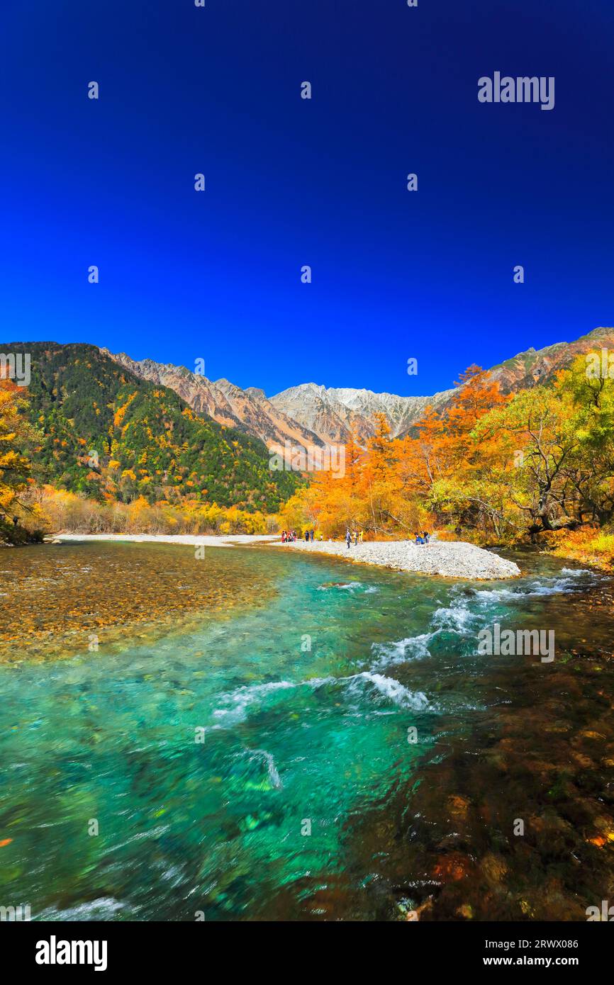 Snow in clear stream of Azusa River and Hotaka mountain range in autumn ...