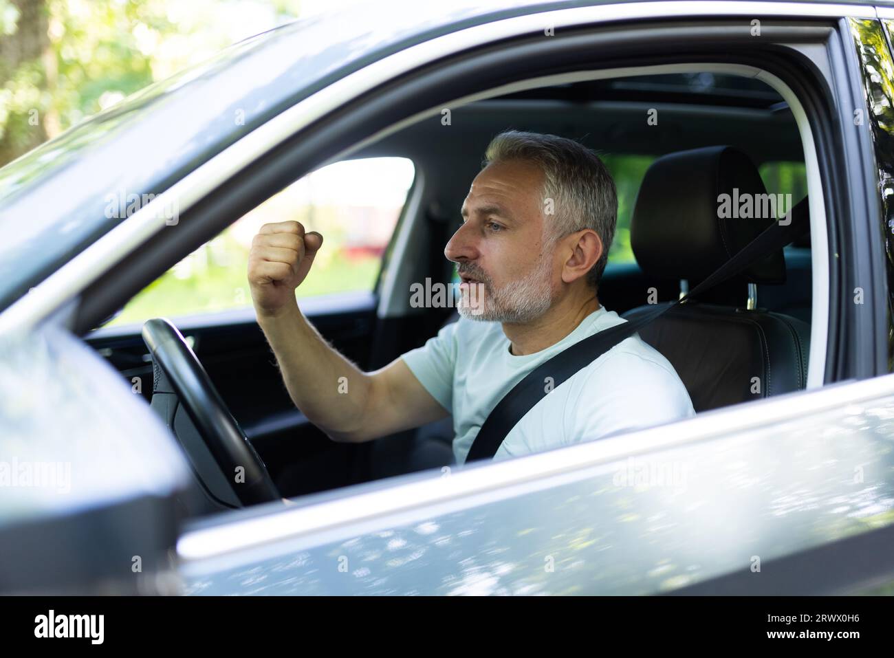 Angry and nervous truck driver yelling at someone in traffic Stock ...