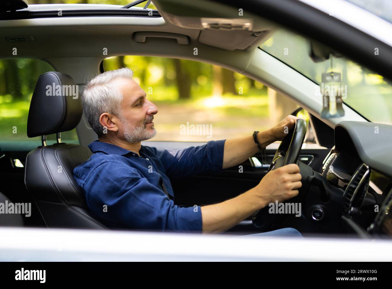 Man driving car in the street Stock Photo - Alamy