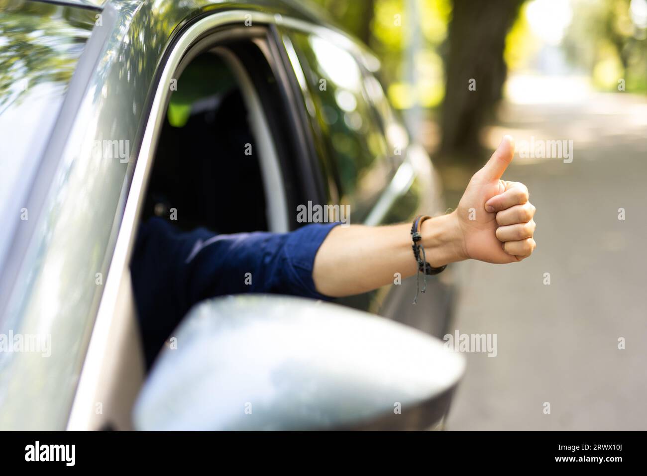 Man in suit leaning out of car window hi-res stock photography and ...