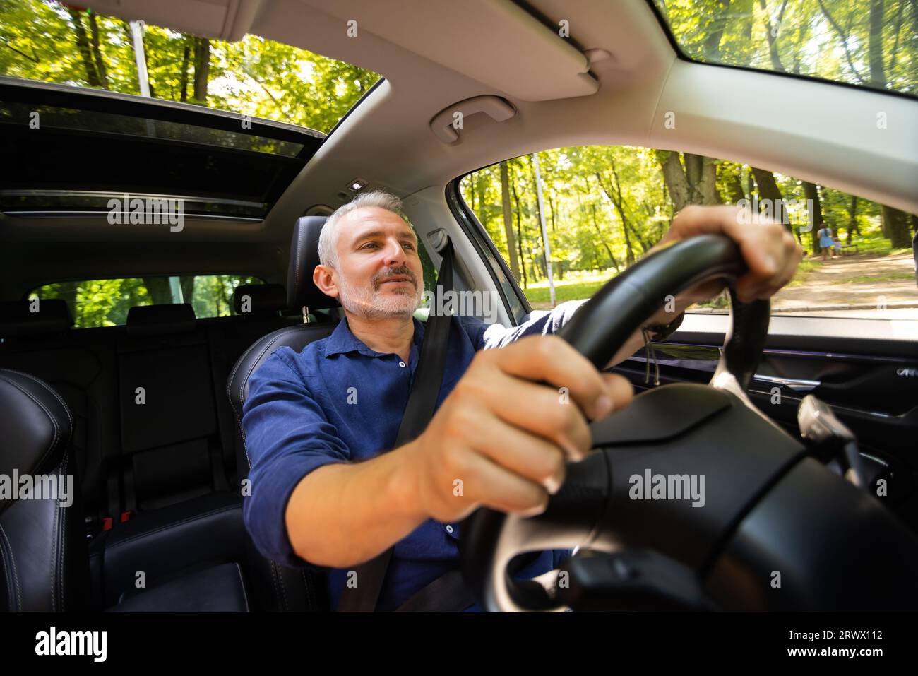 Man driving car in the street Stock Photo - Alamy