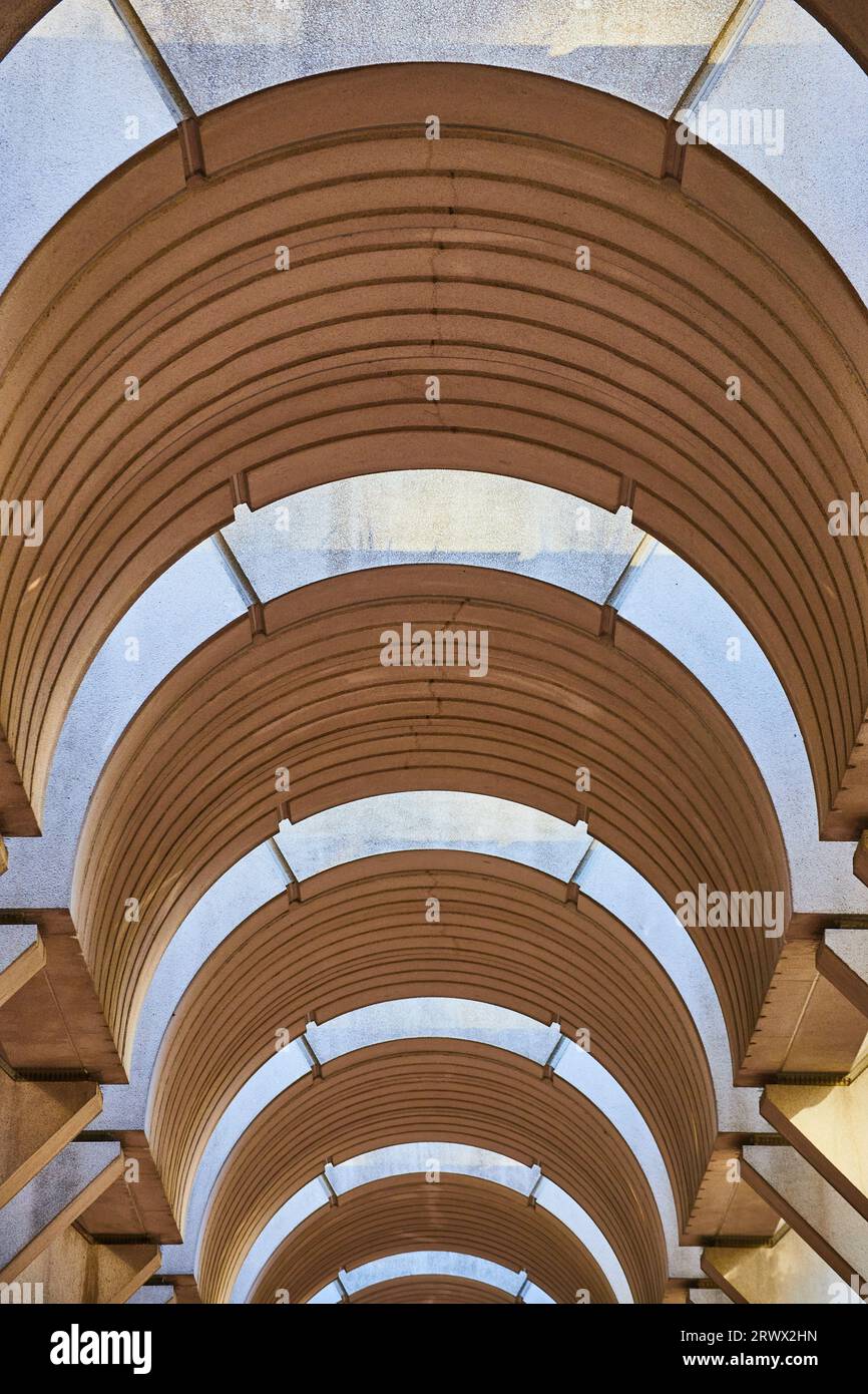 Symmetrical tunnel ceiling with optical illusion openings for sunlight ...