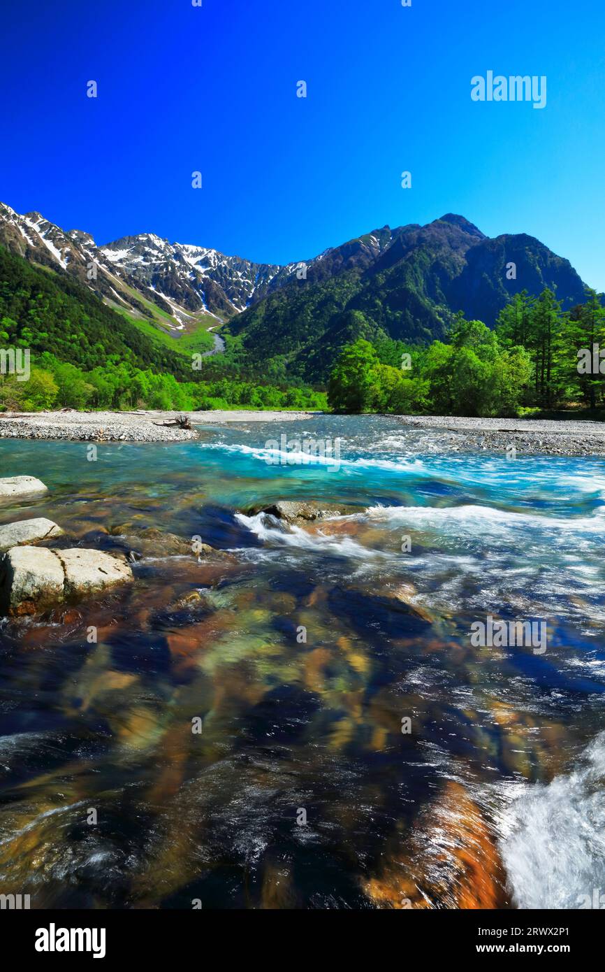 Clear clear Azusa River and snow-capped Hotaka mountain peaks in ...