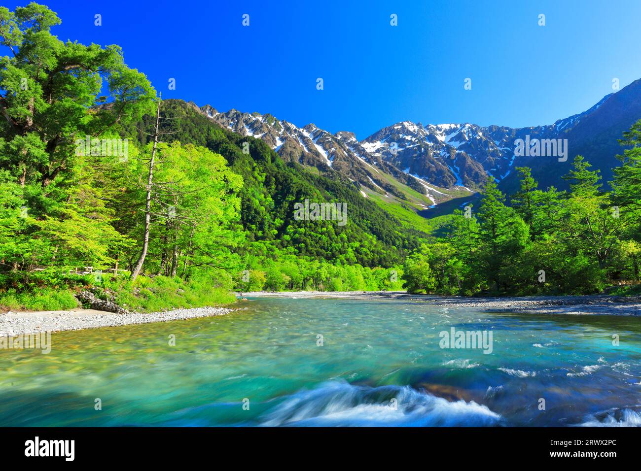Clear clear Azusa River and snow-capped Hotaka mountain peaks in ...