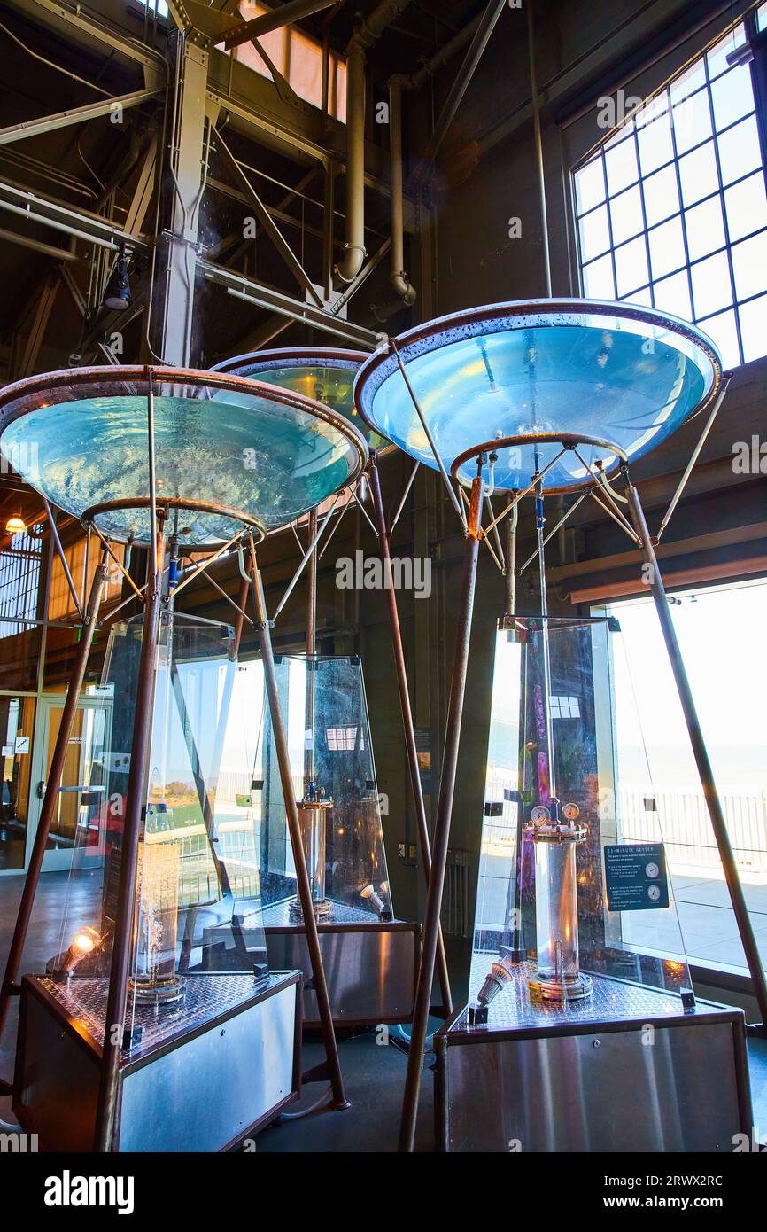 Large bowls of blue and teal water standing up on tall copper legs in ...