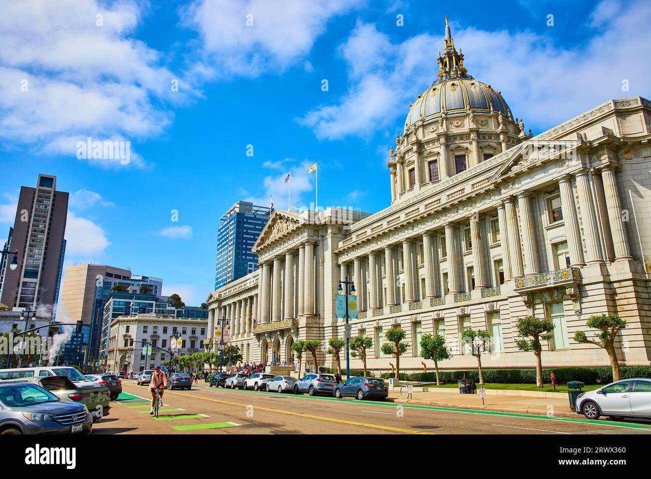 City hall street view with blue sky overhead and puffy white clouds ...