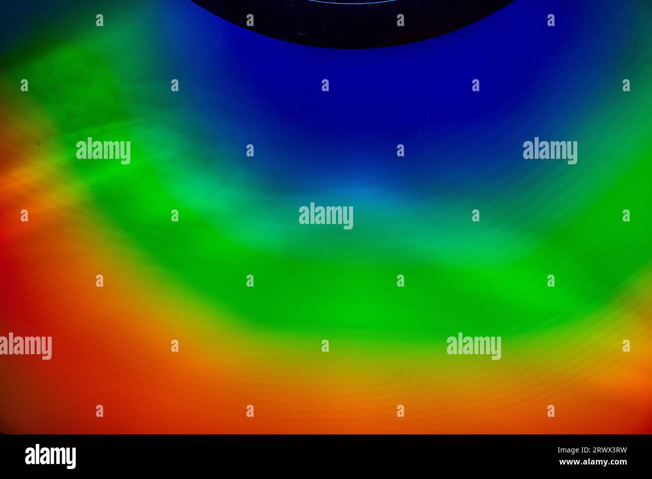 Partial black circle at top with abstract waves of blue and green and ...