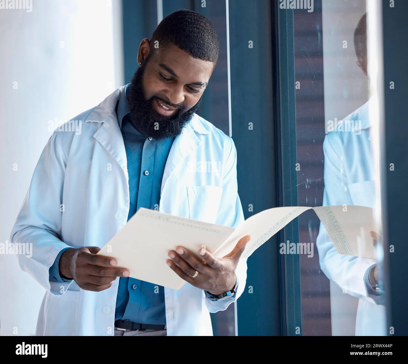 Doctor, man and reading documents, information or paperwork of patient ...