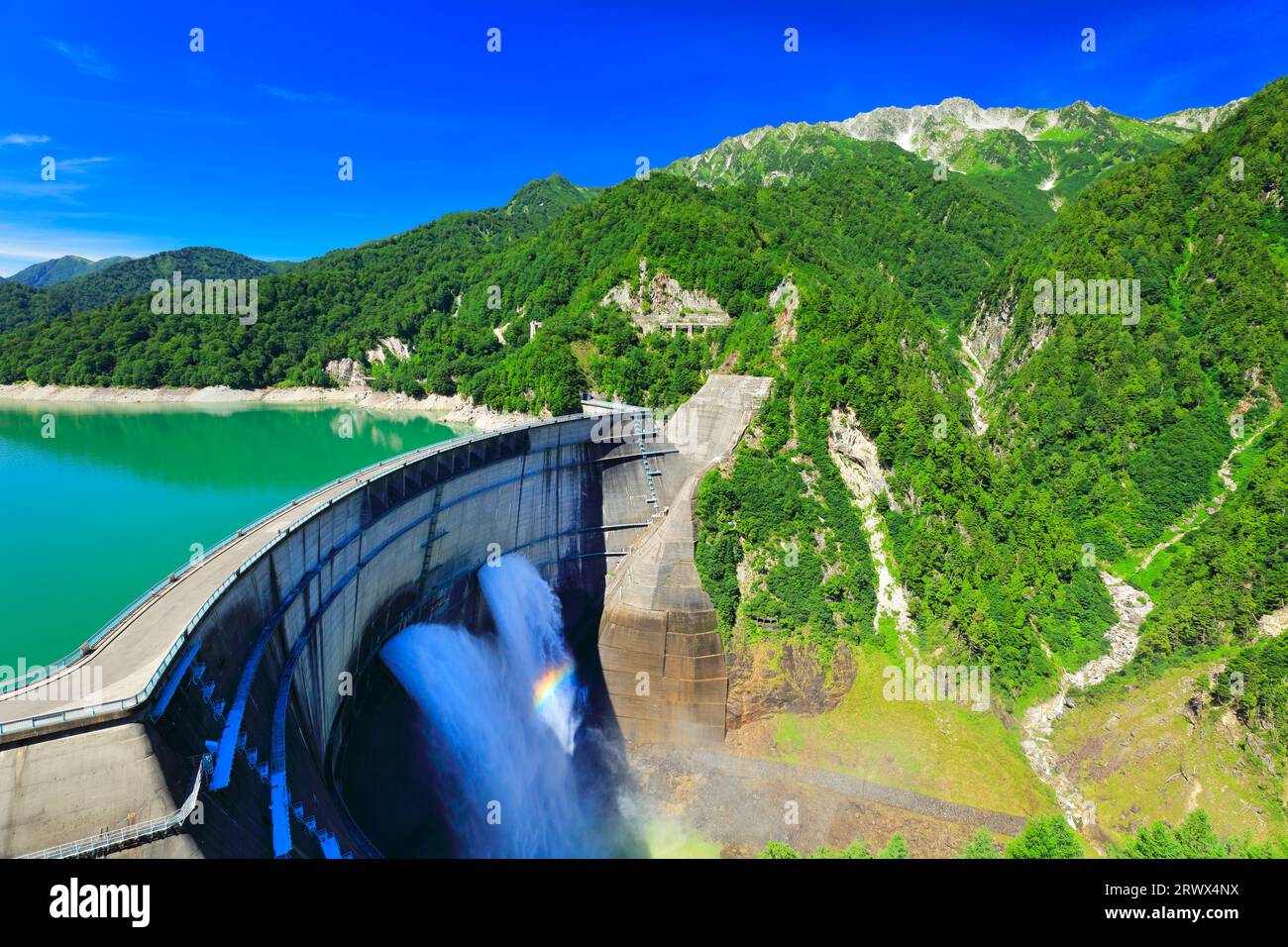 Rainbow and Kurobe Dam water discharge in summer in Tateyama Stock ...