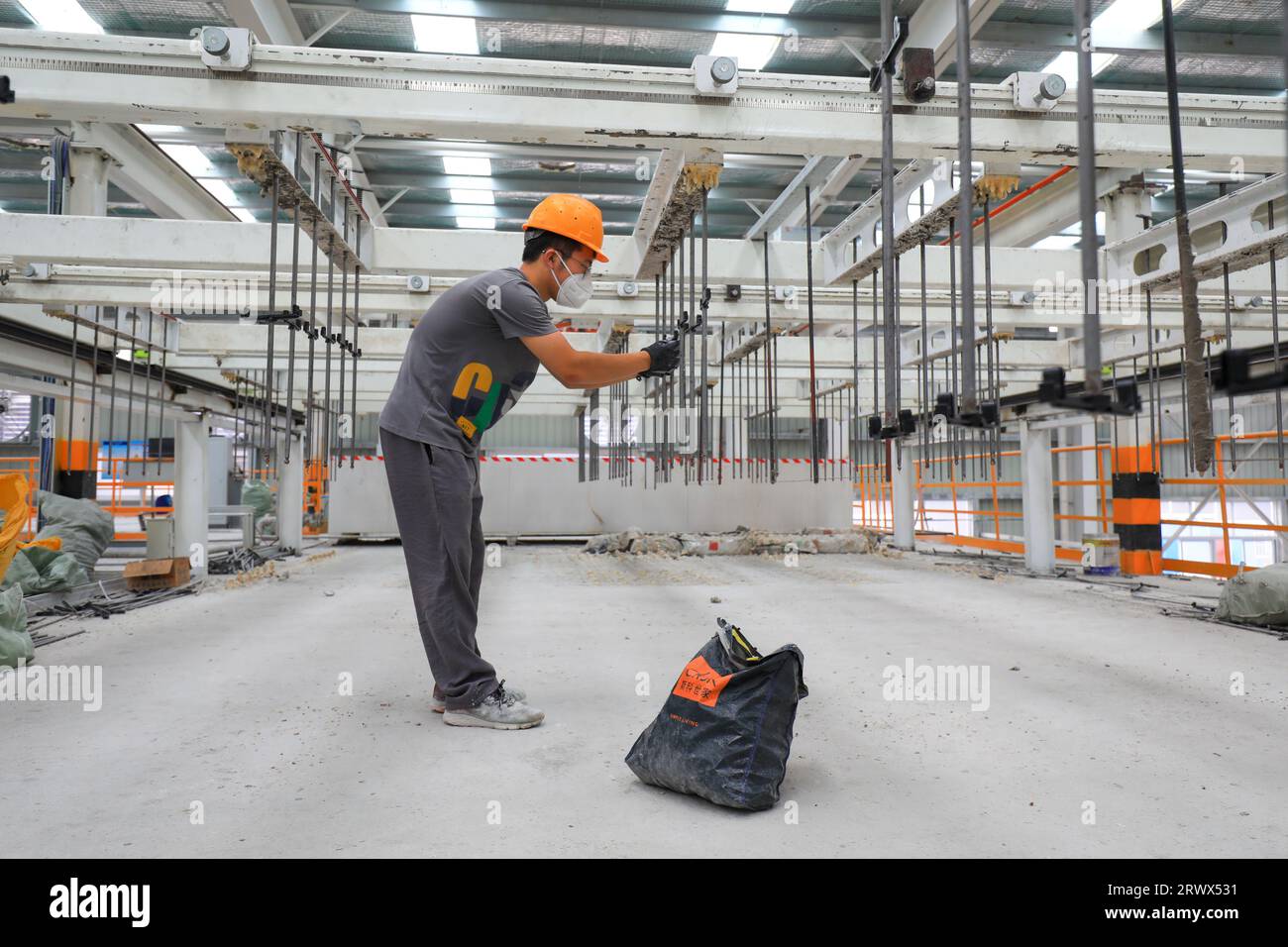 Luannan County, China - June 27, 2023: Workers hang steel mesh on the ...
